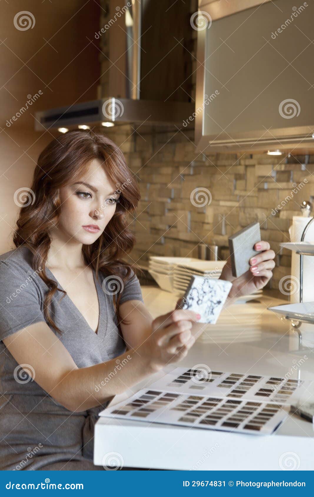 Beautiful Young Woman Looking at Tile Samples in Model Home Stock Image ...