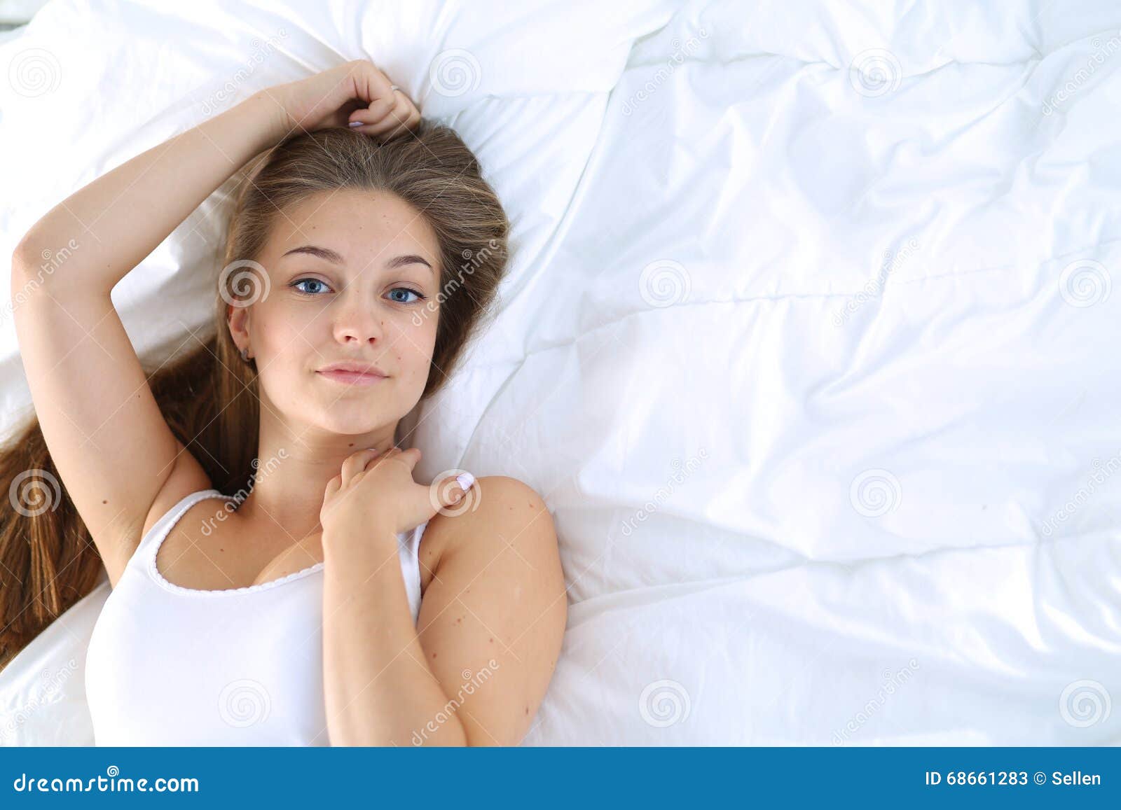 A Beautiful Young Woman Lying In Bed Comfortably And Blissfully Stock