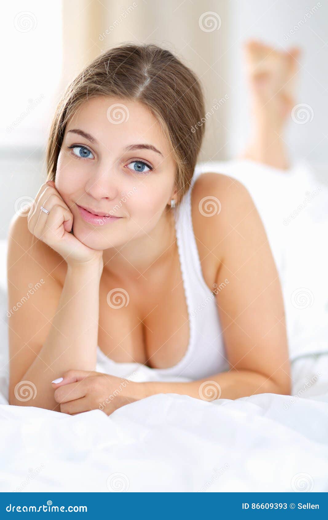 Beautiful Young Woman Lying In Bed Comfortably And Blissfully Stock