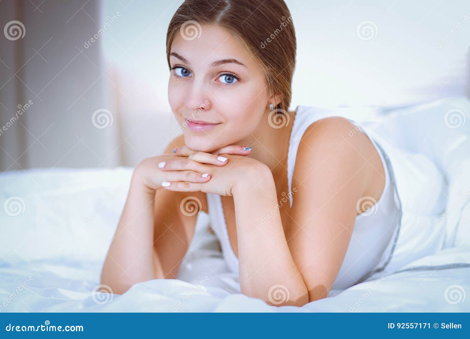 Beautiful Young Woman Lying In Bed Comfortably And Blissfully Stock