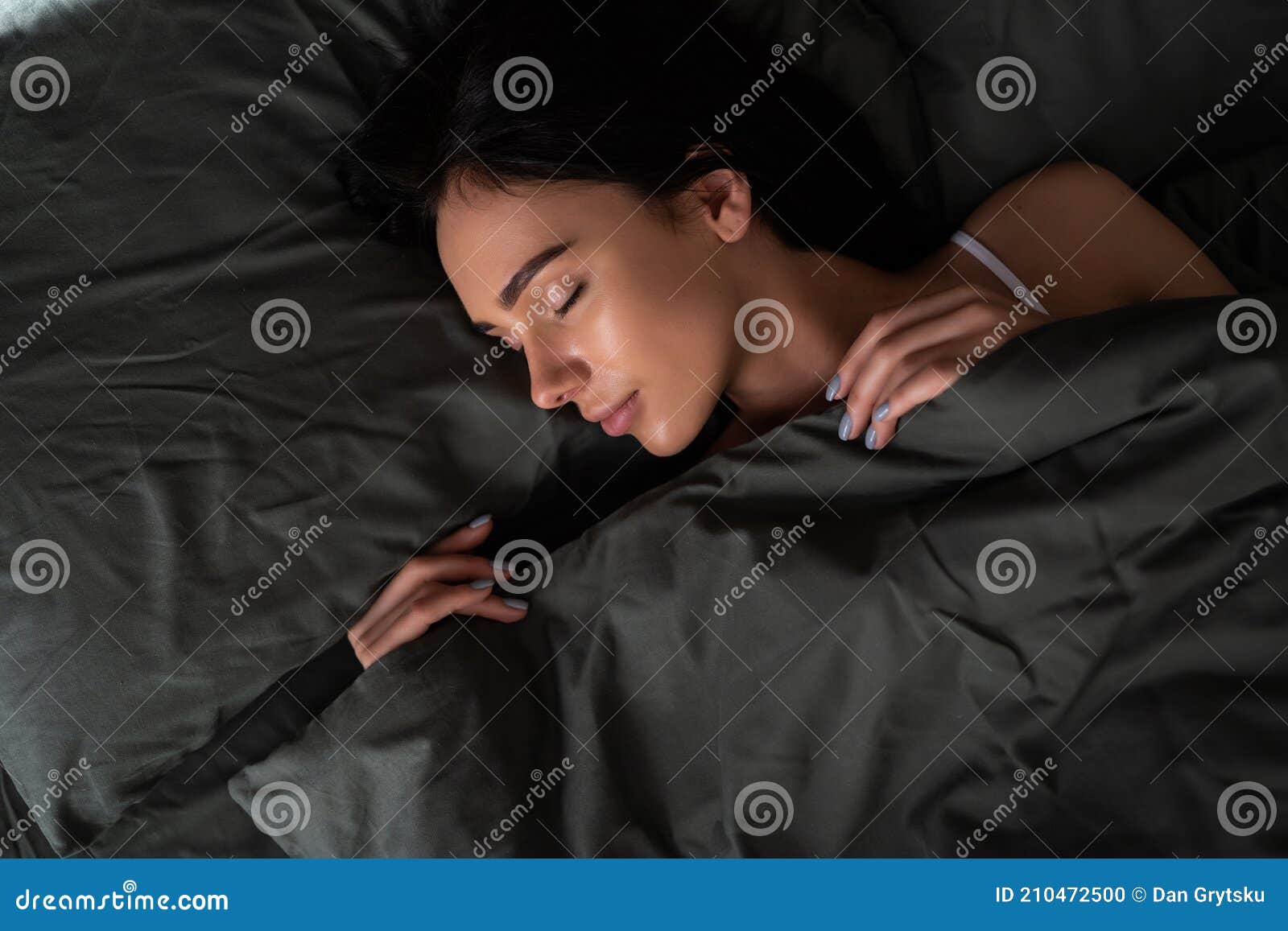 Beautiful Young Woman Lying In Bed Comfortably And Blissfully Stock