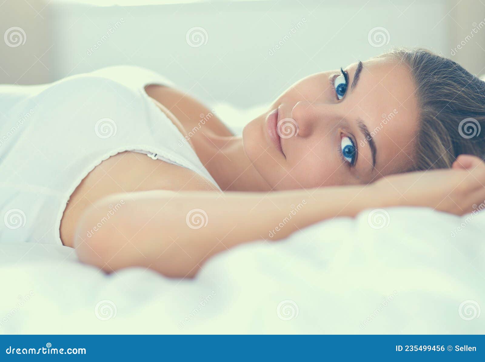 Beautiful Young Woman Lying In Bed Comfortably And Blissfully Stock