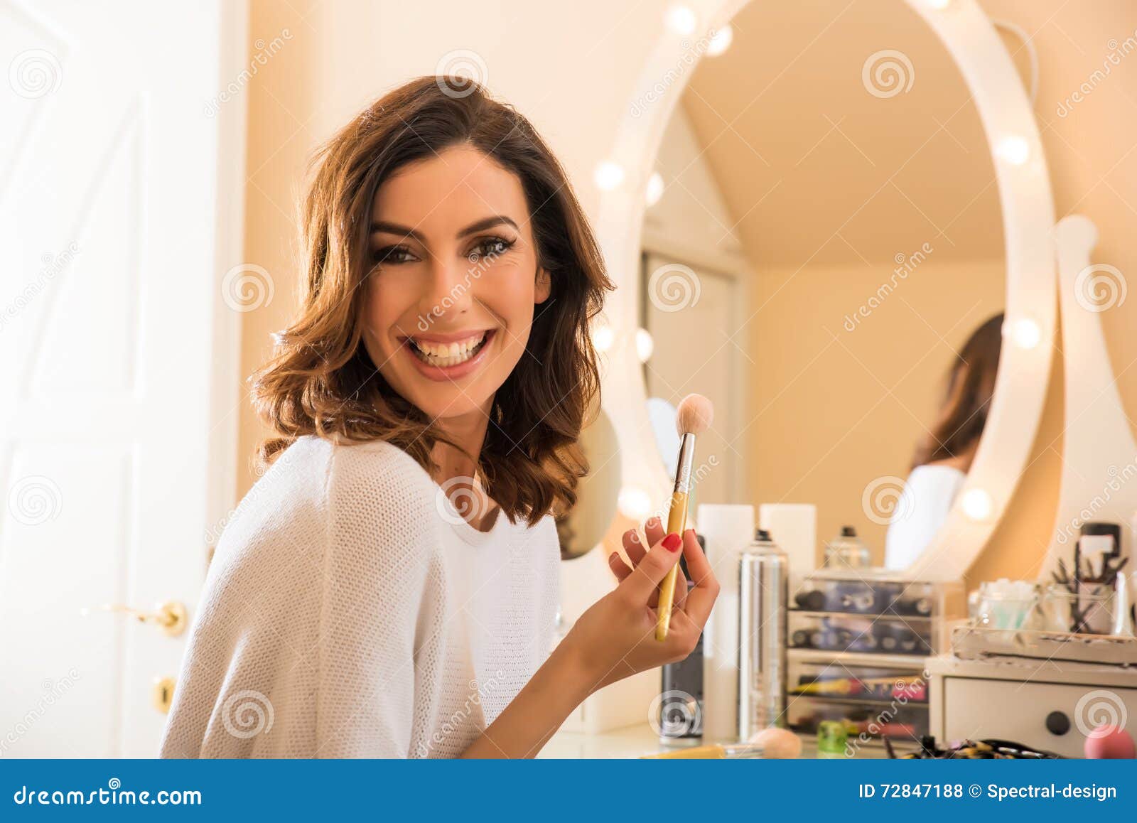A Beautiful Young Woman at a Makeup Table Stock Photo - Image of brush ...