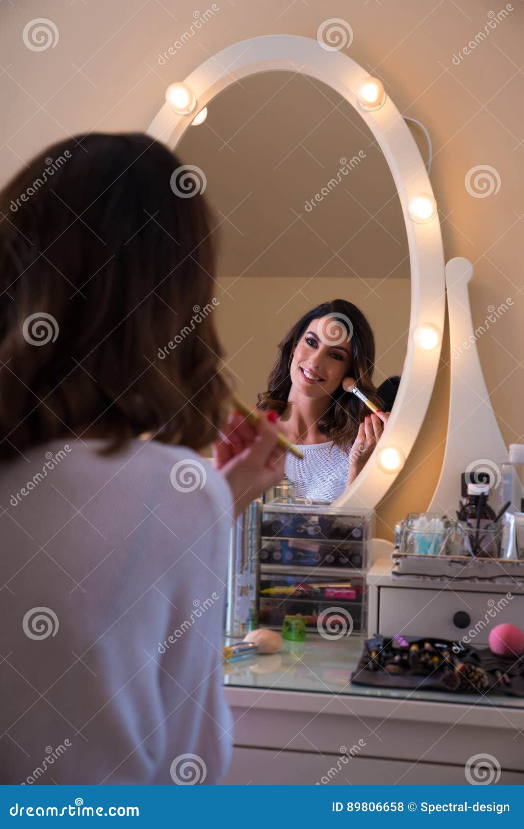 A Beautiful Young Woman at a Makeup Table Stock Photo - Image of ...