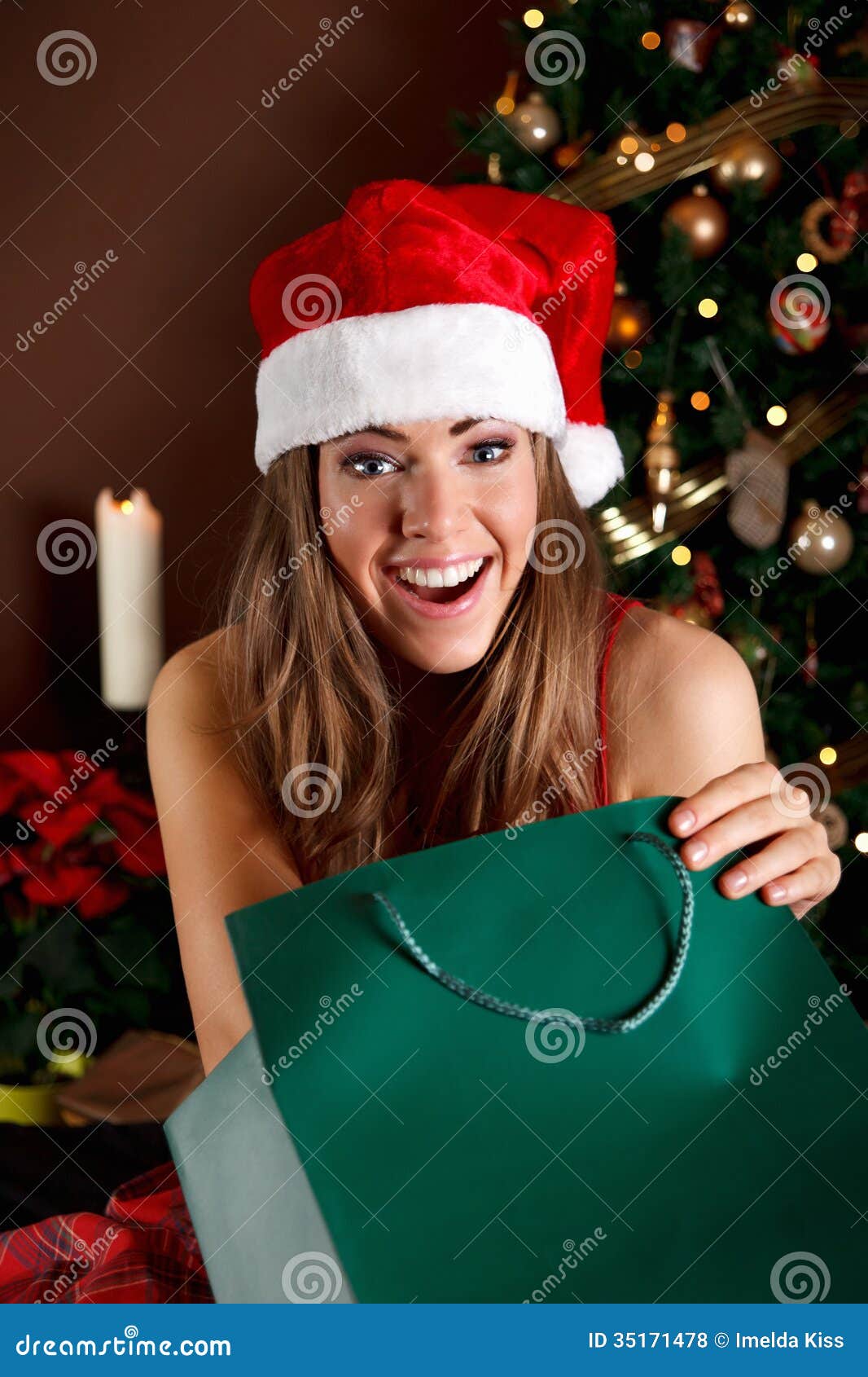 Beautiful Young Woman Opening a Christmas Gift Stock Photo - Image of ...