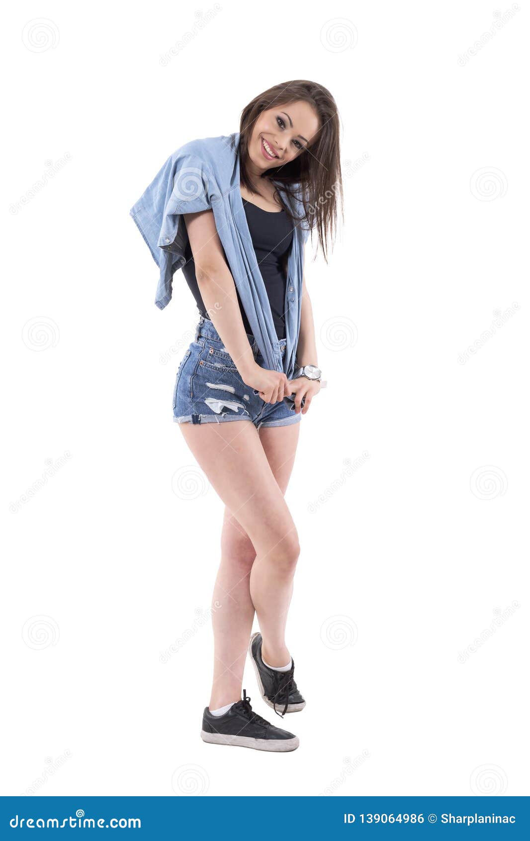 Beautiful Young Woman Posing With Slinging Denim Jacket Over Shoulder