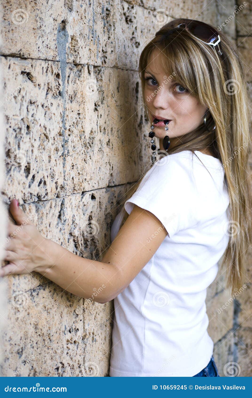 Beautiful Young Woman Posing on Wall Stock Image - Image of feminine ...