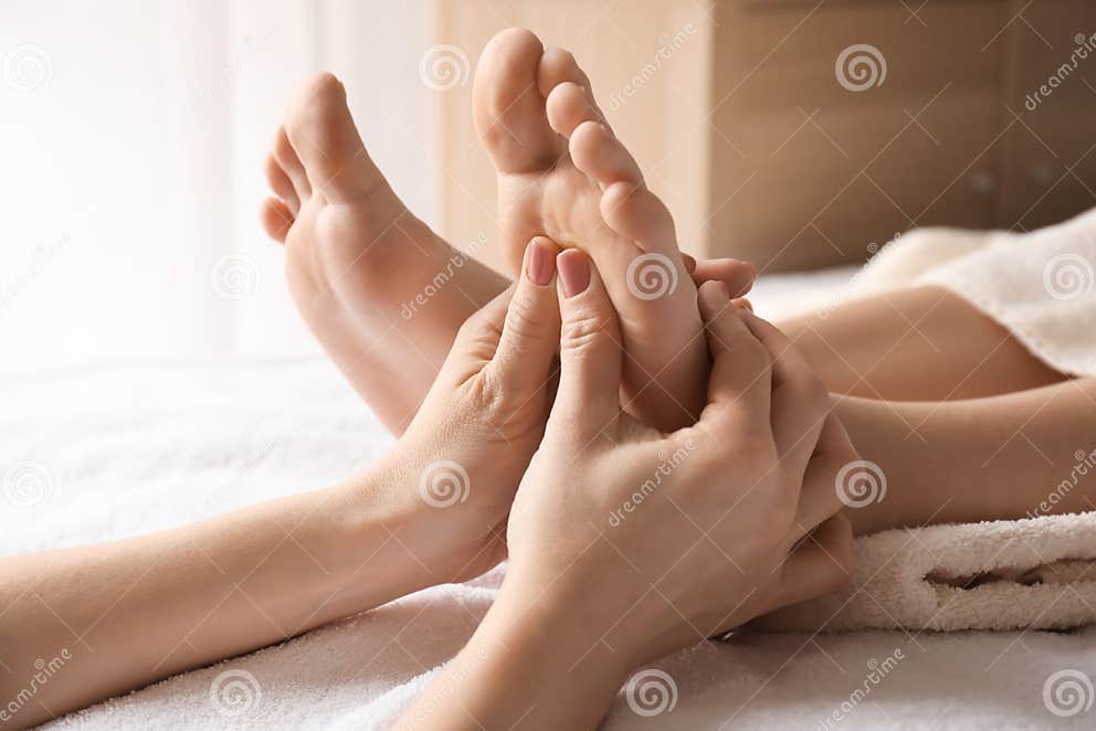 Beautiful Young Woman Receiving Foot Massage In Spa Salon Stock Image