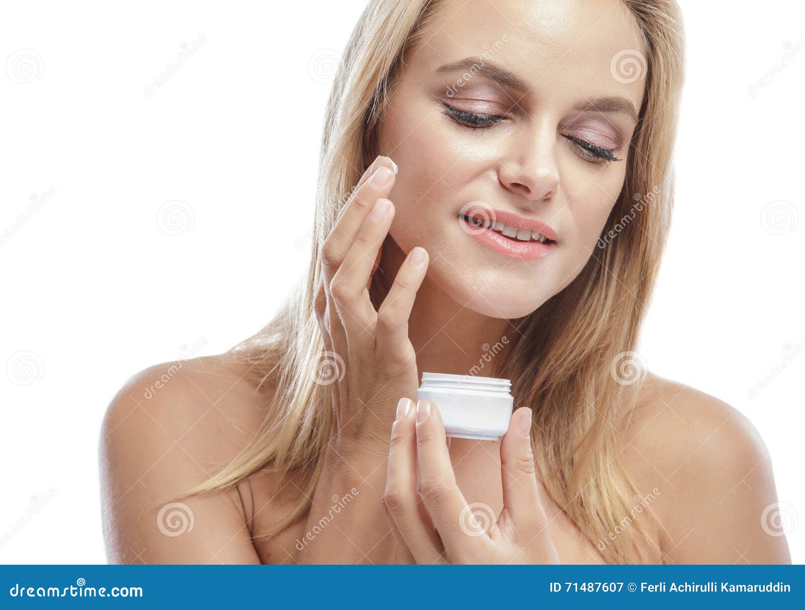 Beautiful Young Woman Smiling While Adding Facial Cream Stock Image