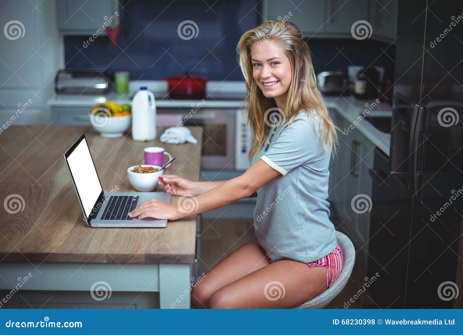 Beautiful Young Woman Smiling while Using Laptop at Table Stock Photo ...