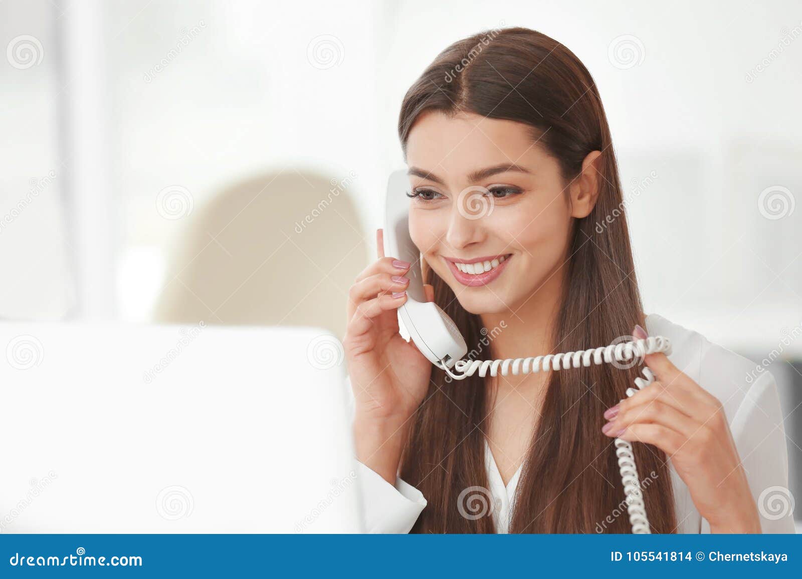 Beautiful Young Woman Talking by Telephone while Working with Computer ...
