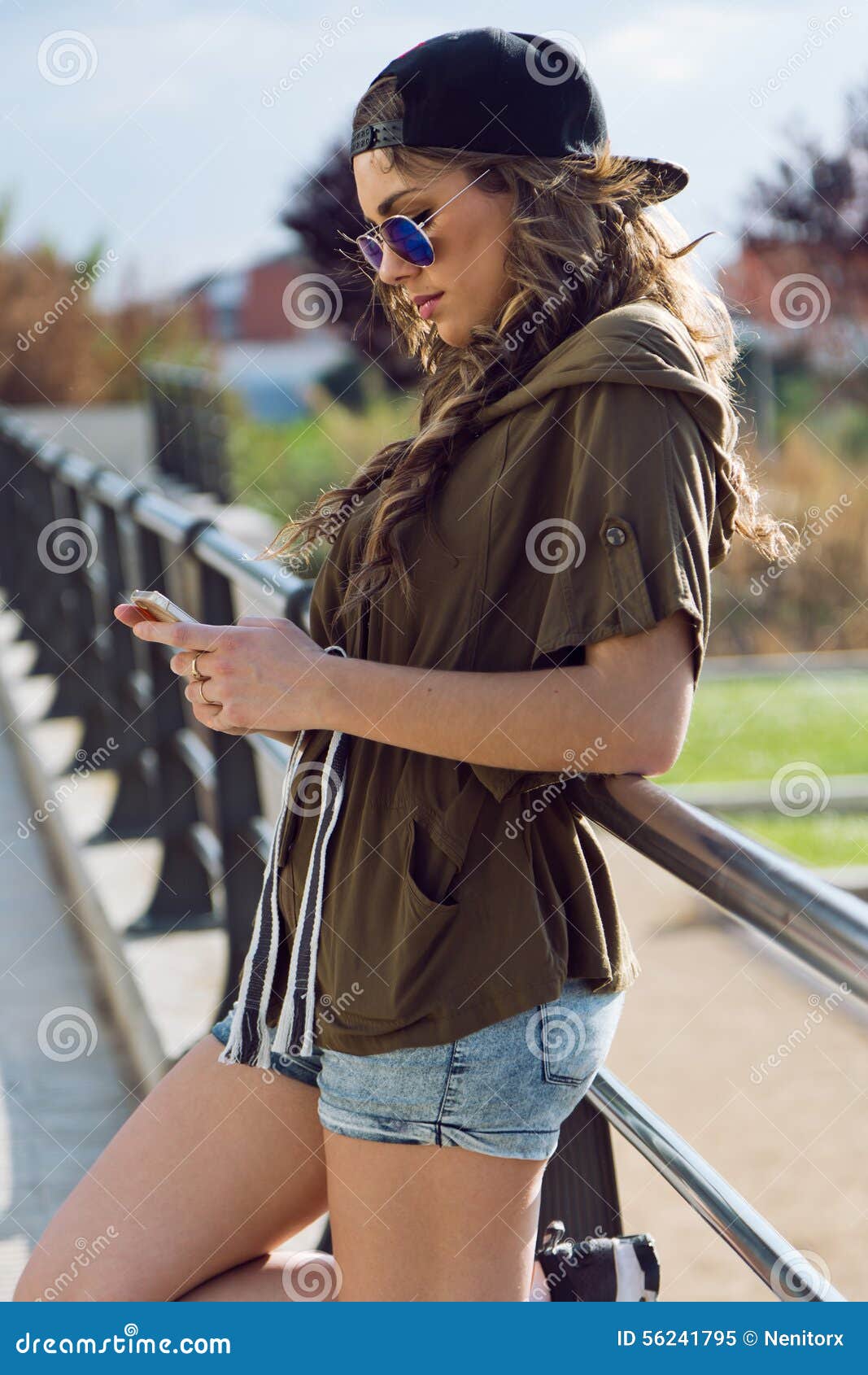 Beautiful Young Woman Using Her Mobile Phone In The Street Stock Image