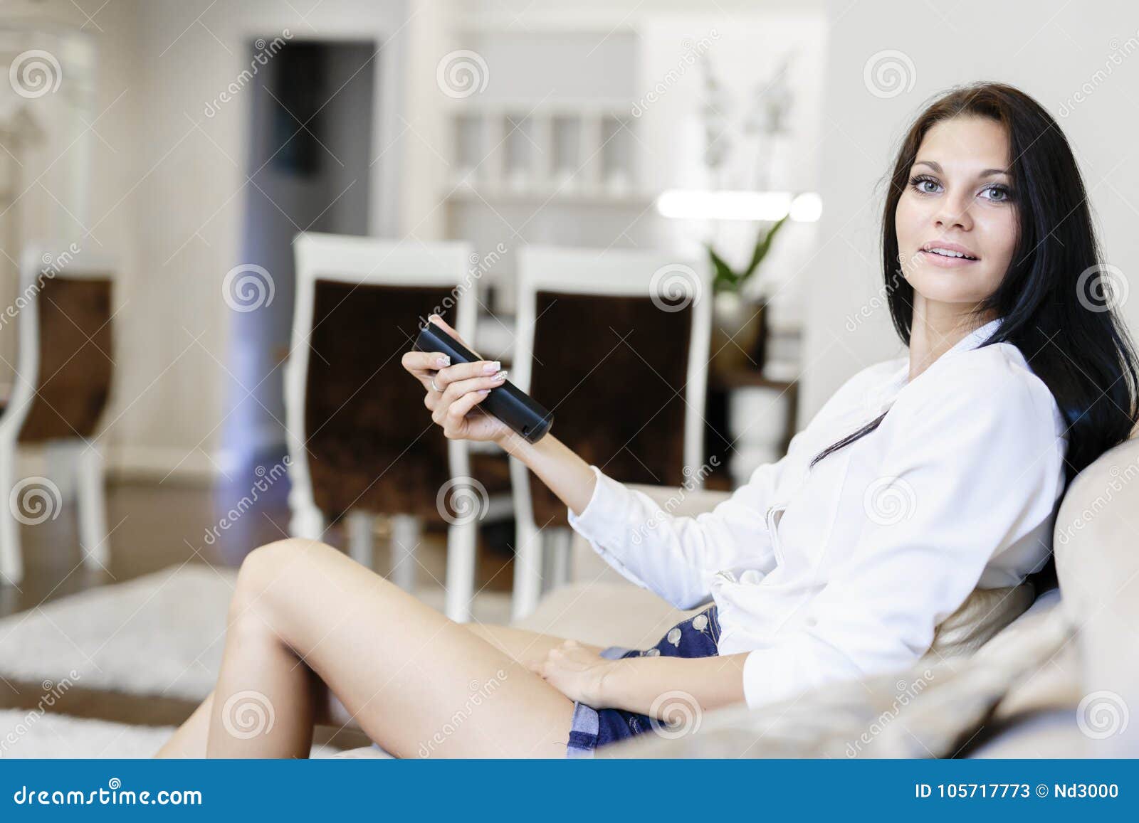 Beautiful Young Woman Using Remote Control in Living Room Stock Image ... Beautiful Young Woman Using Remote Control in Living Room Stock Image ...