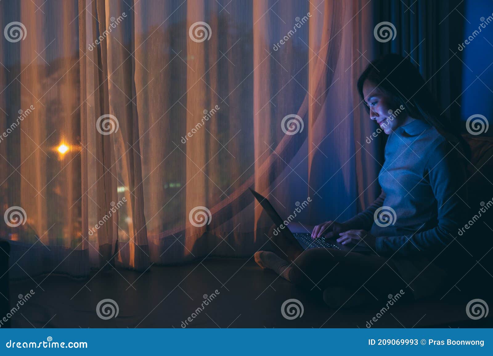 A Young Woman Using and Working on Laptop Computer with Bright Light ...