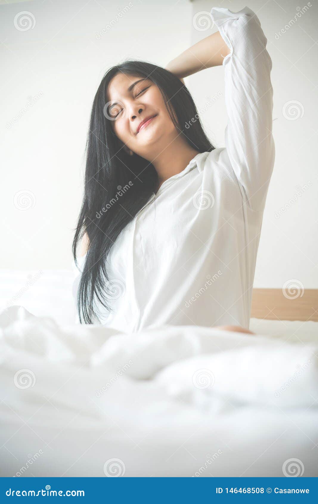 Beautiful Young Woman Wake Up And Stretch Oneself In The Morning At