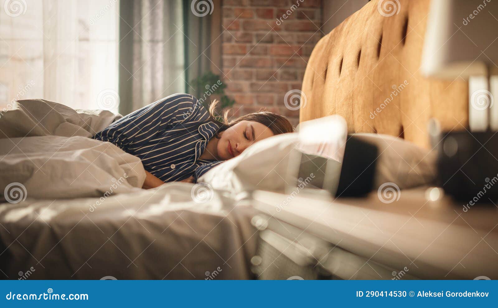 Beautiful Young Woman Waking Up In The Morning Stretches And Gets Out