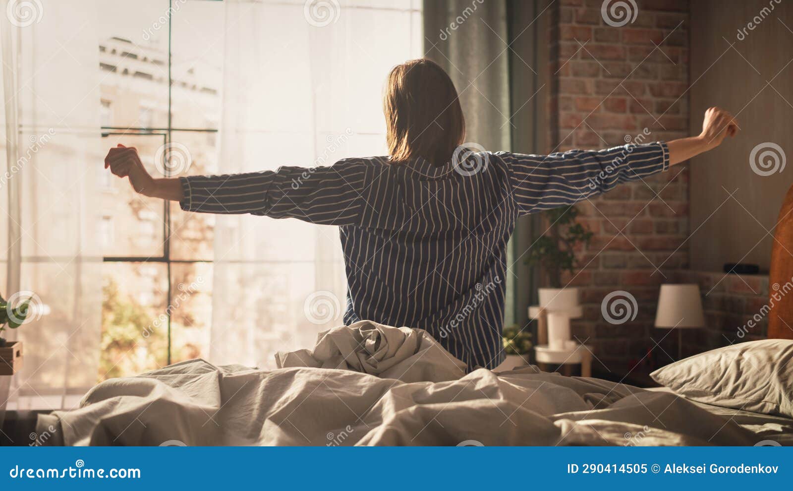 Beautiful Young Woman Waking Up In The Morning Stretches And Gets Out