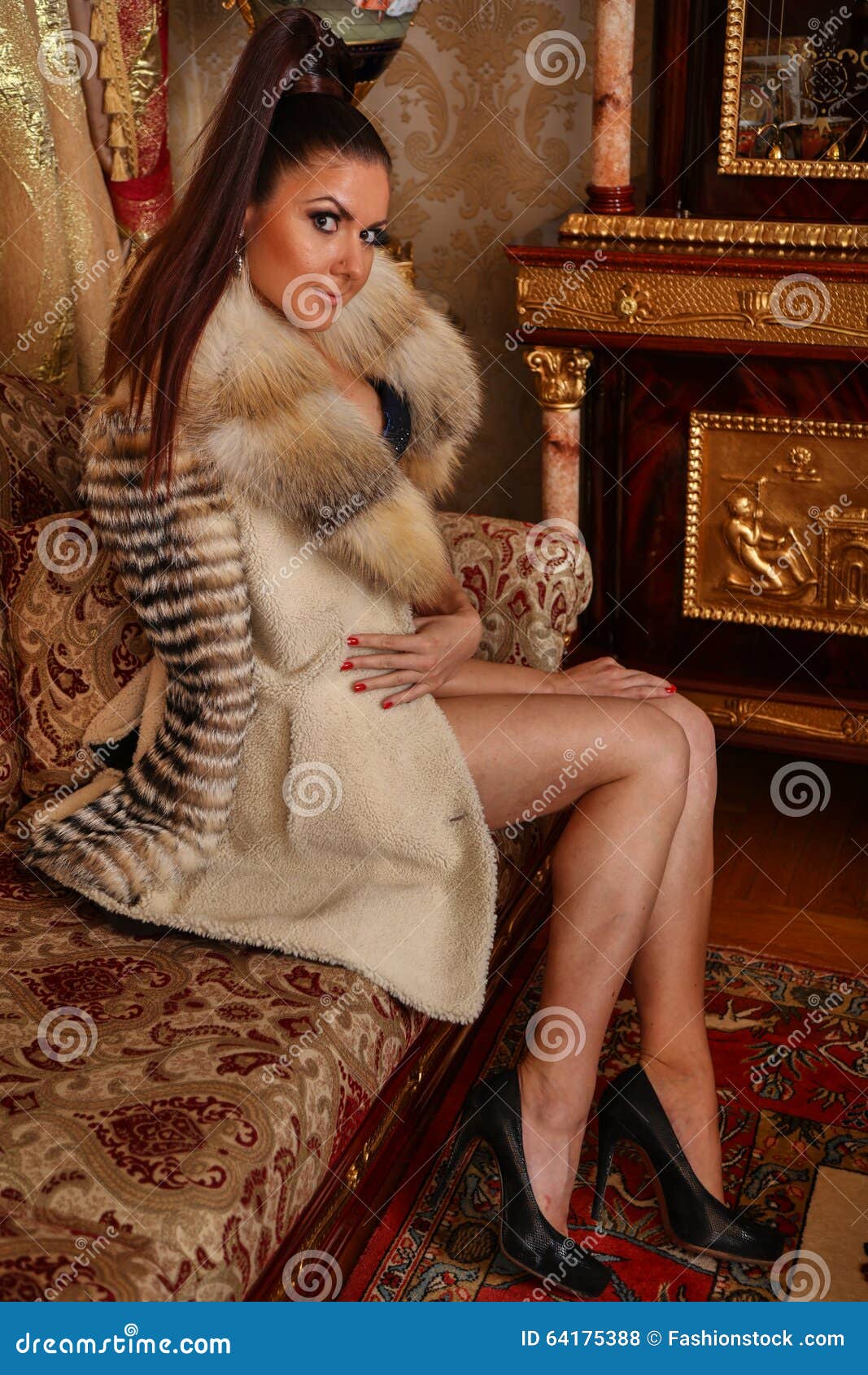 Beautiful Young Woman Wearing Lingerie And Elegant Fur Coat Sitting On