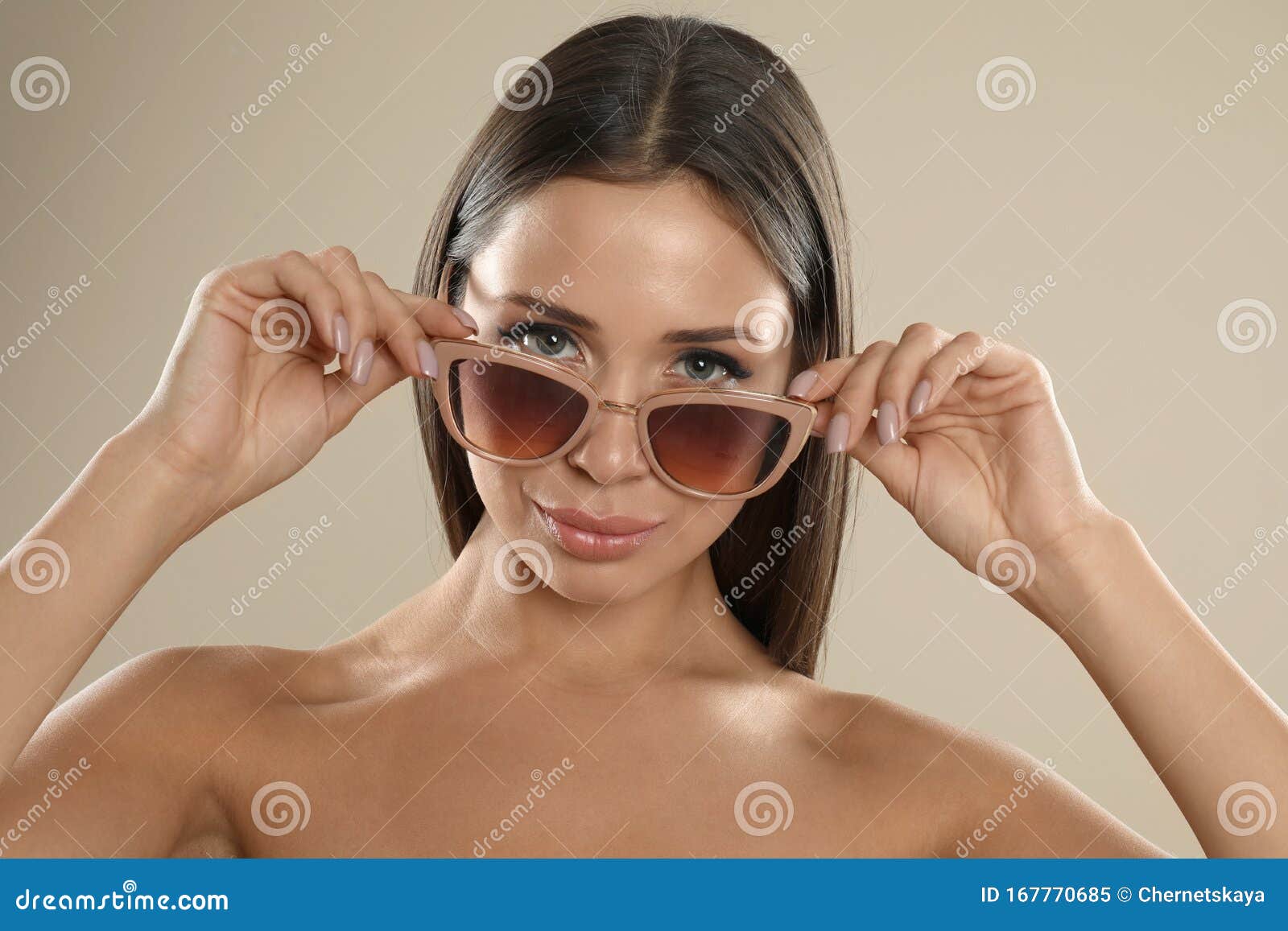 Beautiful Young Woman Wearing Sunglasses On Background Stock Image