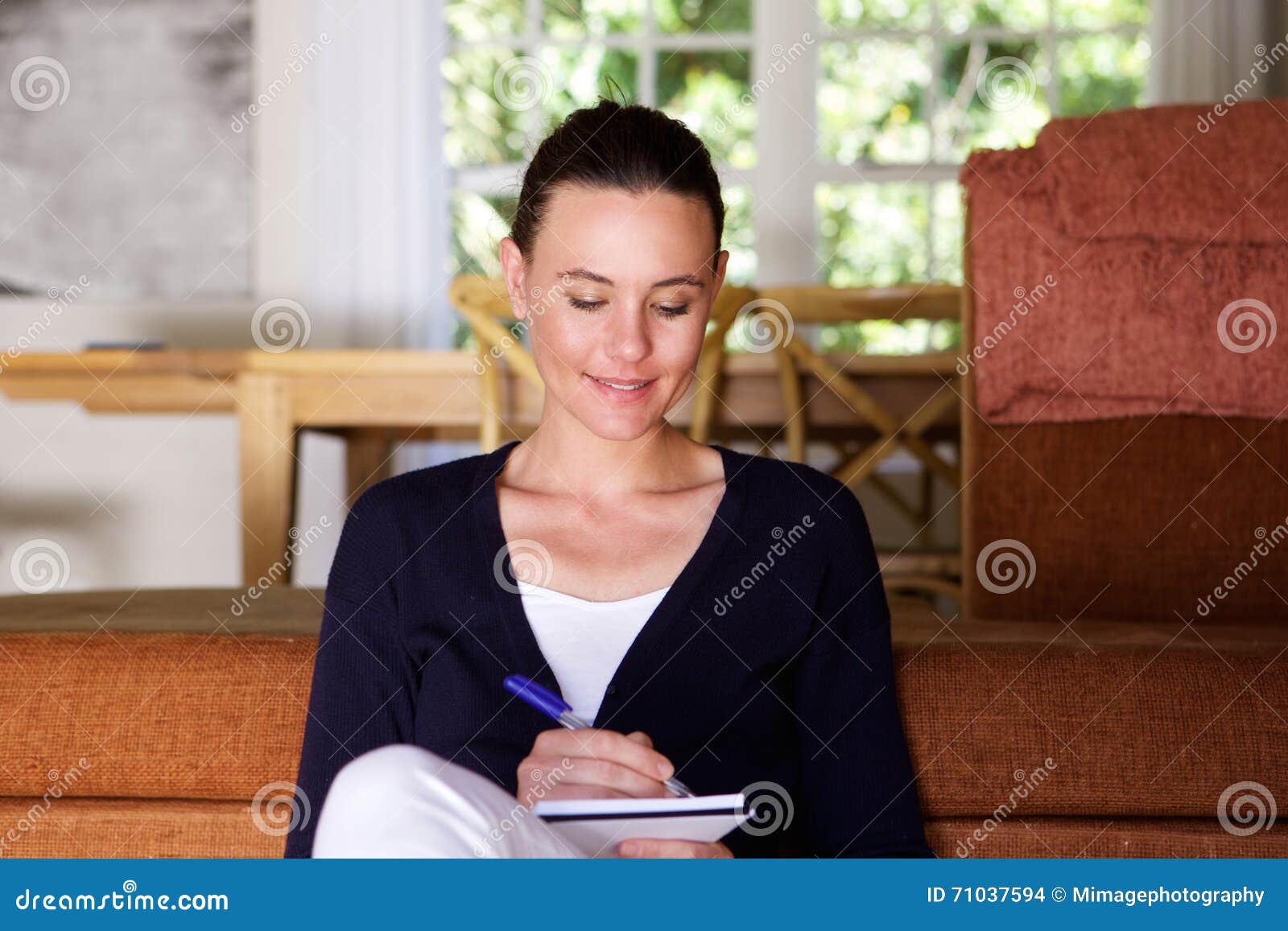 Beautiful Young Woman Writing on Note Pad at Home Stock Photo - Image ...