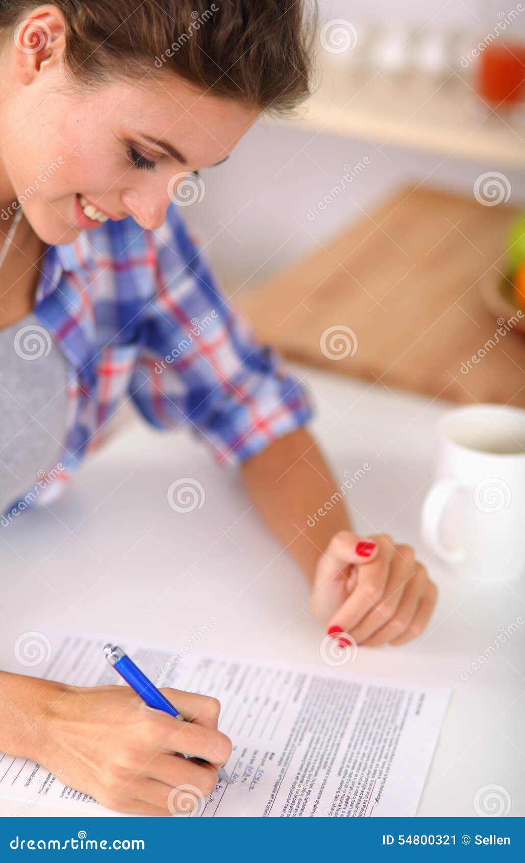 Beautiful Young Woman Writing Something in Her Note Pad. Stock Image ...