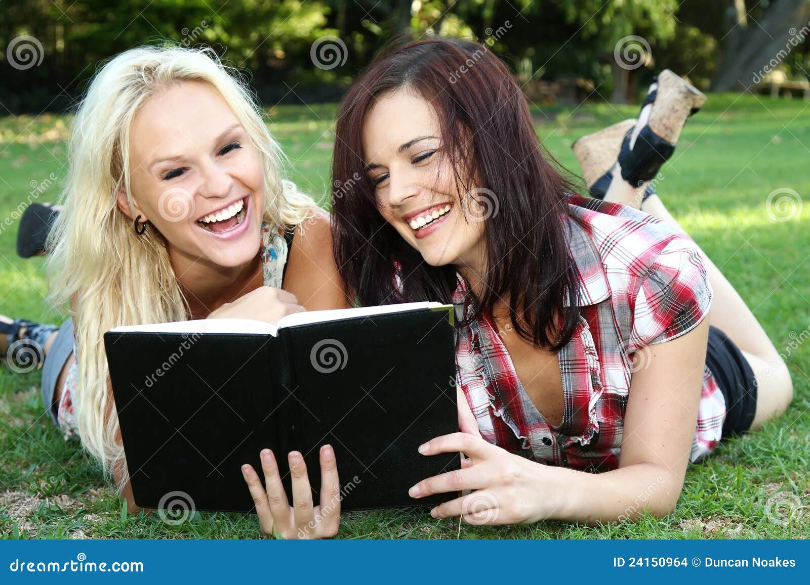 Beautiful Young Women Friends Reading Outdoors Stock Photo - Image of ...