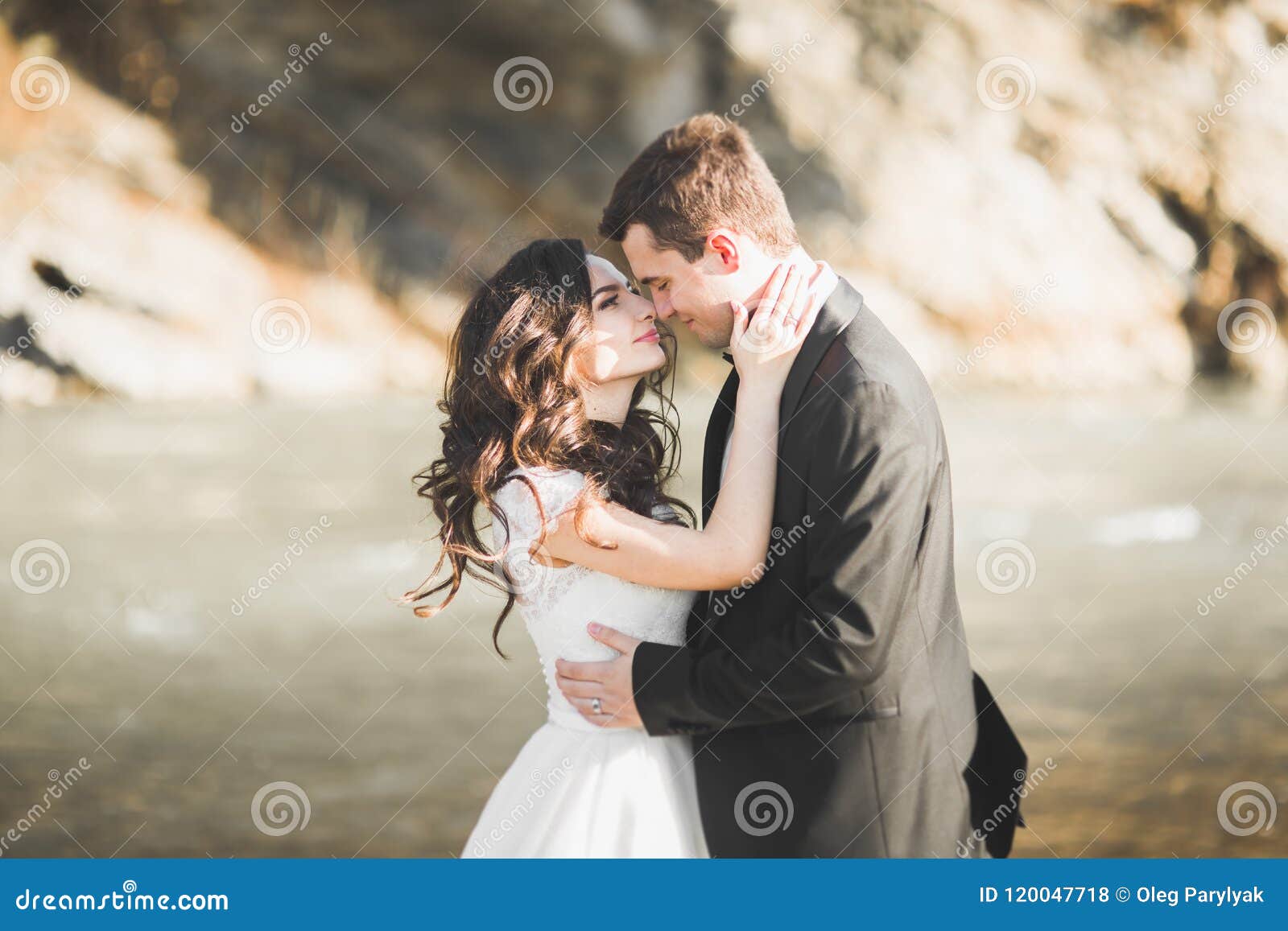 Beautifull Wedding Couple Kissing And Embracing Near The Shore Of A