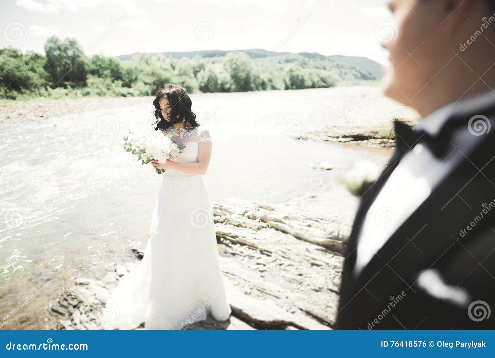 Beautifull Wedding Couple Kissing And Embracing Near The Shore Of A