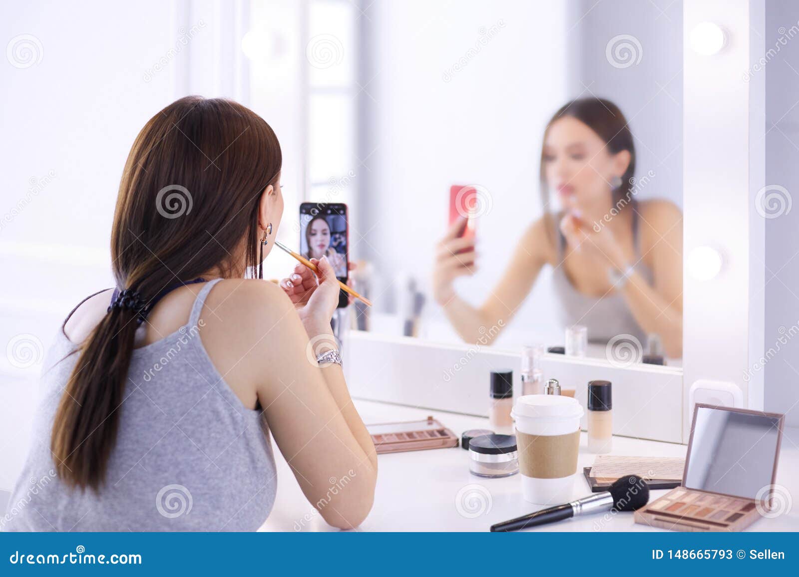 Beauty Blogger Filming Makeup Tutorial with Smartphone in Front of ...