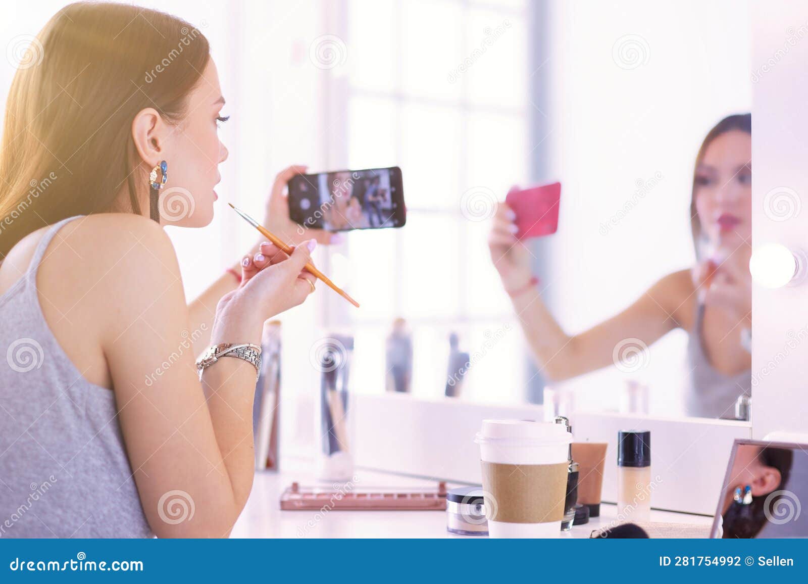 Beauty Blogger Filming Makeup Tutorial with Smartphone in Front of ...