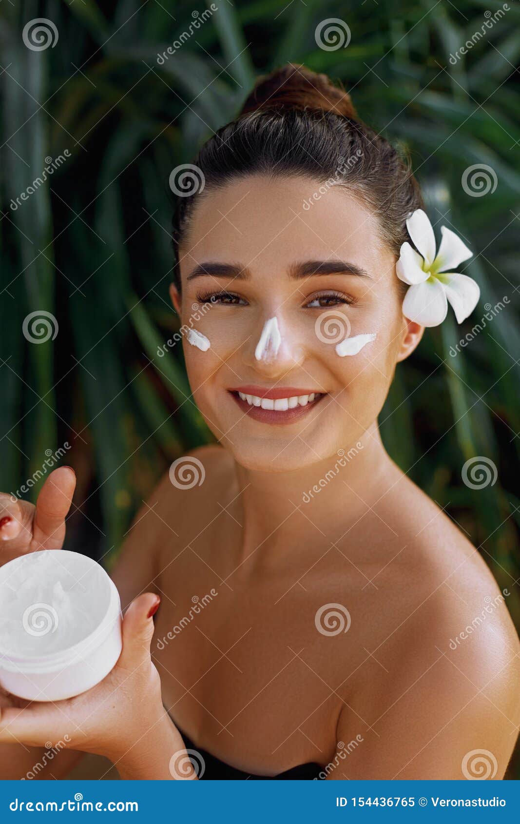 Beauty Concept Woman Applying Cosmetics Cream And Smiling Female