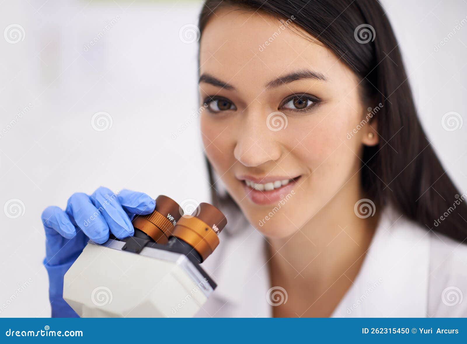 Beauty and Intellect. Portrait of a Female Scientist Using a Microscope ...