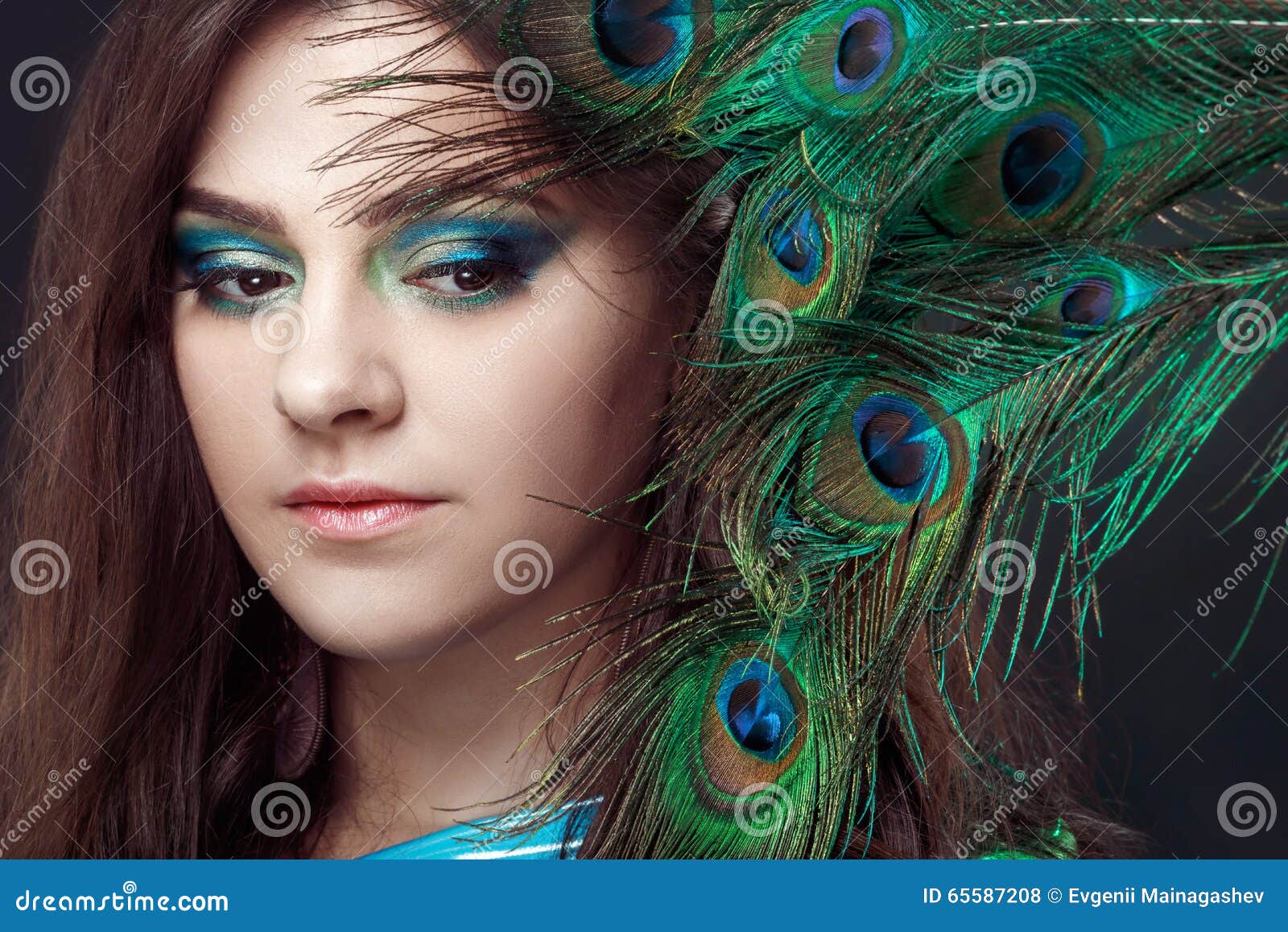 Beauty Portrait Of Beautiful Girl Covering The Eyes With Peacock