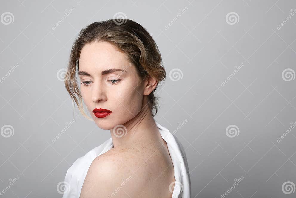 Beauty Portrait Of Young Woman With Red Lips Wearing White Clothing