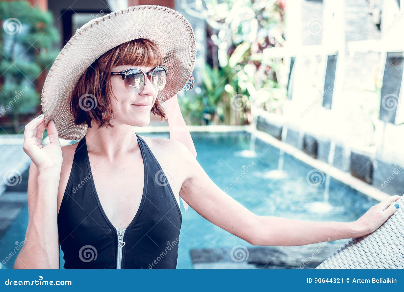 Beauty Woman With Hat And Sunglasses Enjoying Her Summer Vacation At