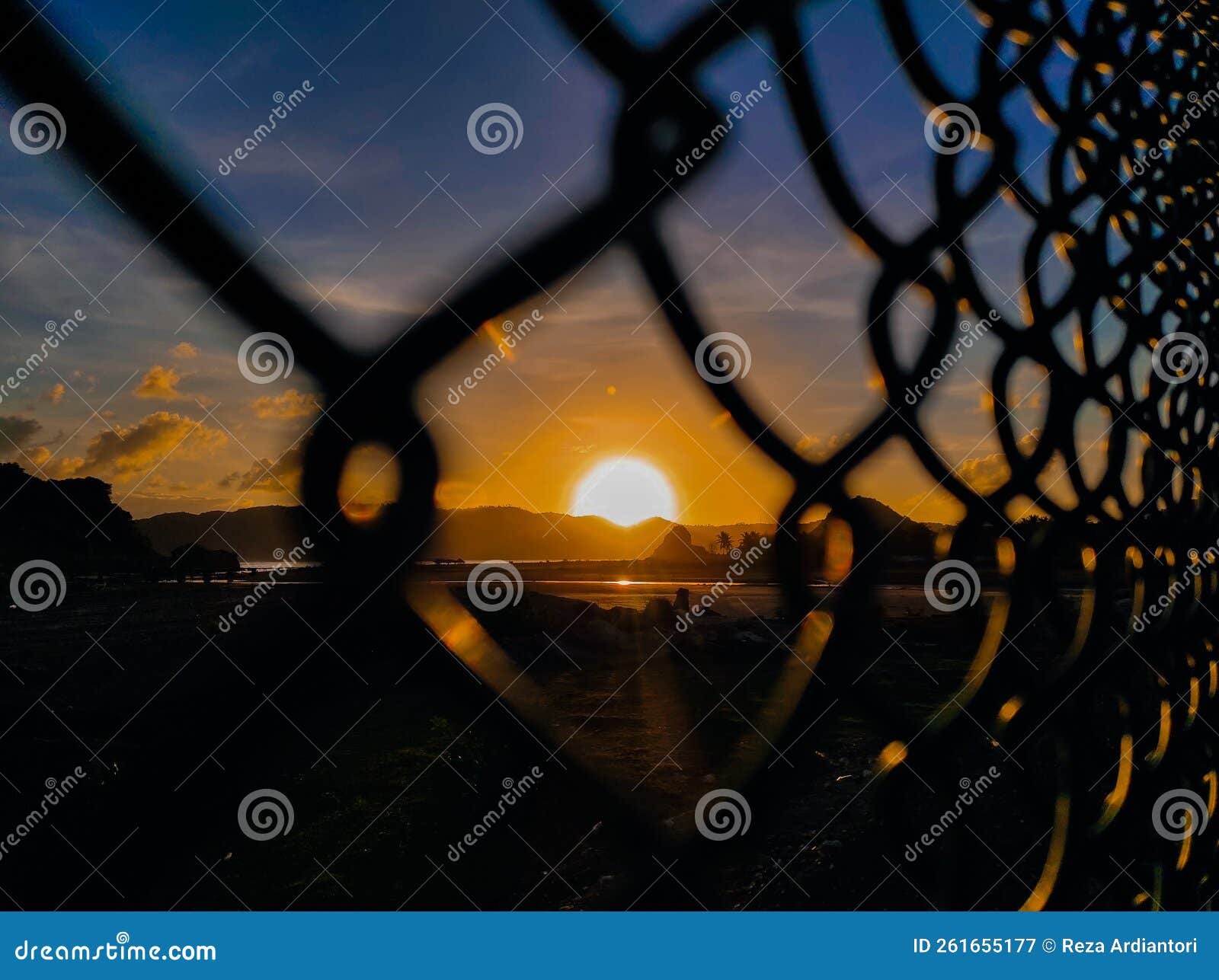 The Beauty of the Sunset through the Iron Net Fence Stock Image - Image ...