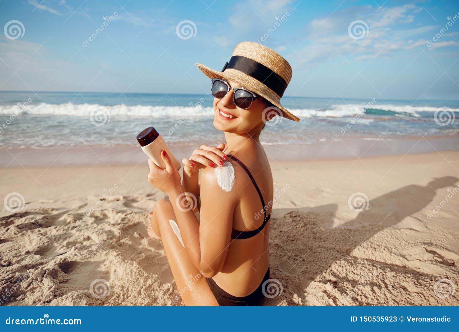 Beauty Woman Applying Sun Cream On Tanned Shoulder Skin And Body Care