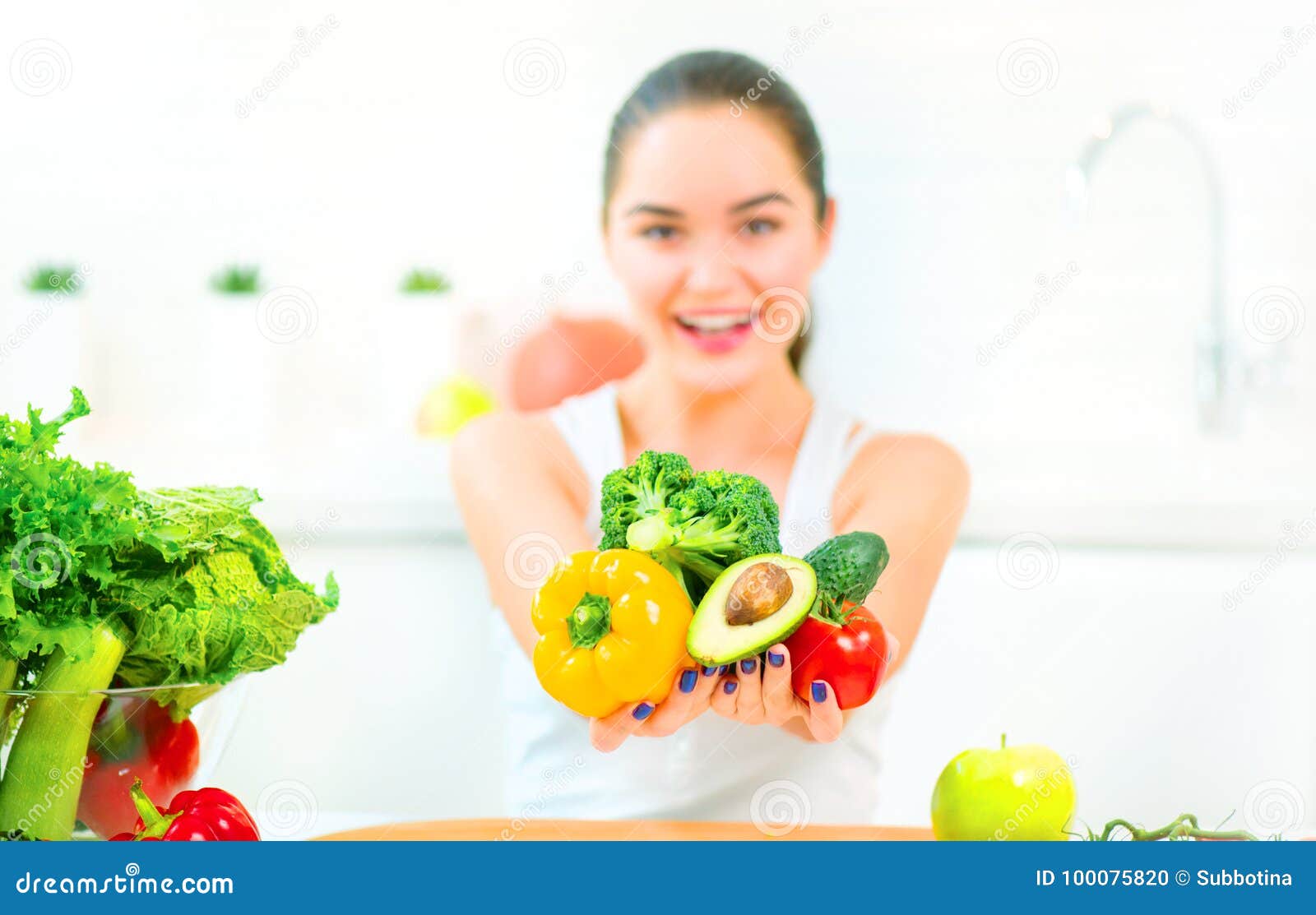 Beauty Young Woman Holding Fresh Vegetables and Fruits in Her Kitchen ... Beauty Young Woman Holding Fresh Vegetables and Fruits in Her Kitchen ...