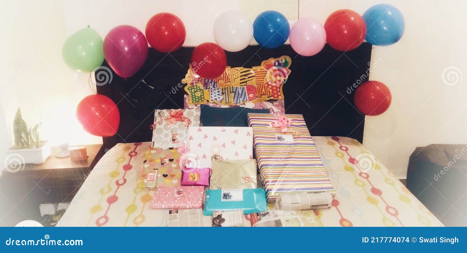 Bed Full of Gifts and Balloons Stock Photo - Image of balloons, gifts ...
