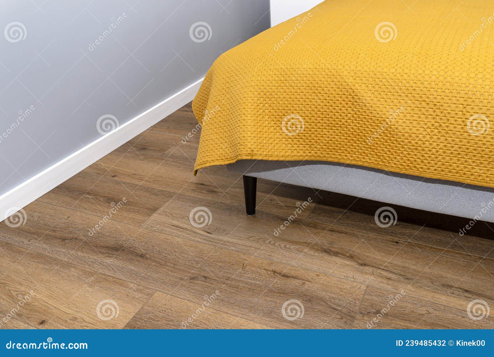 A Bed in a Modern Bedroom with a Mustard Bedspread, Simple Look. Stock ...