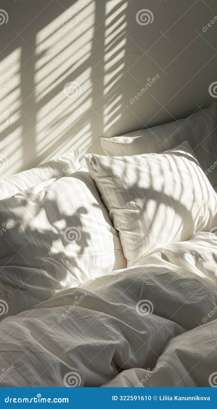 A Bed with White Sheets and Pillows, Emphasizing Its Disheveled State ...