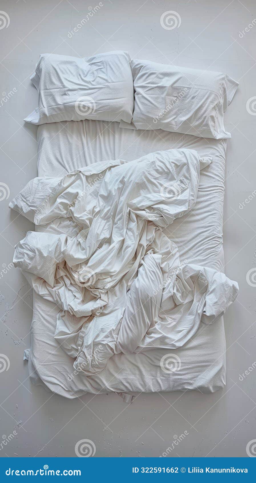 A Bed with White Sheets and Pillows, Emphasizing Its Disheveled State ...