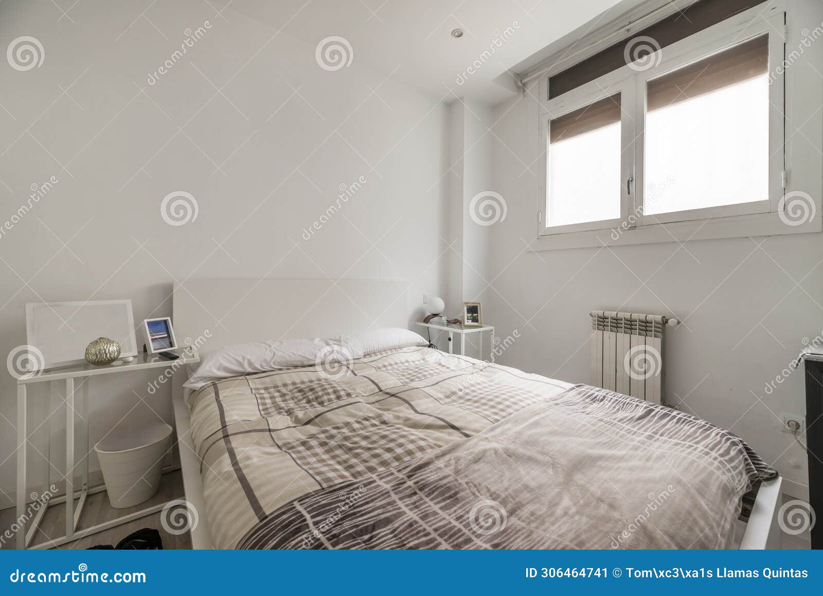 A Bedroom with a Bed on a Sofa, a Small Table and a High Window on the ...