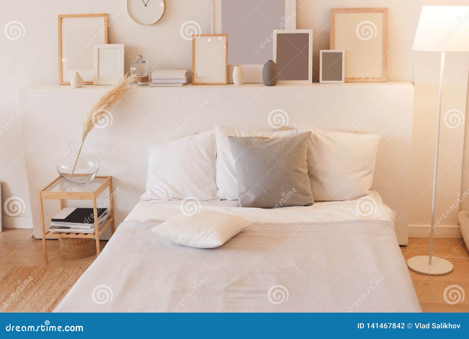 Bedroom with Switched on Floor Lamp and Photo Frames Stock Photo ...