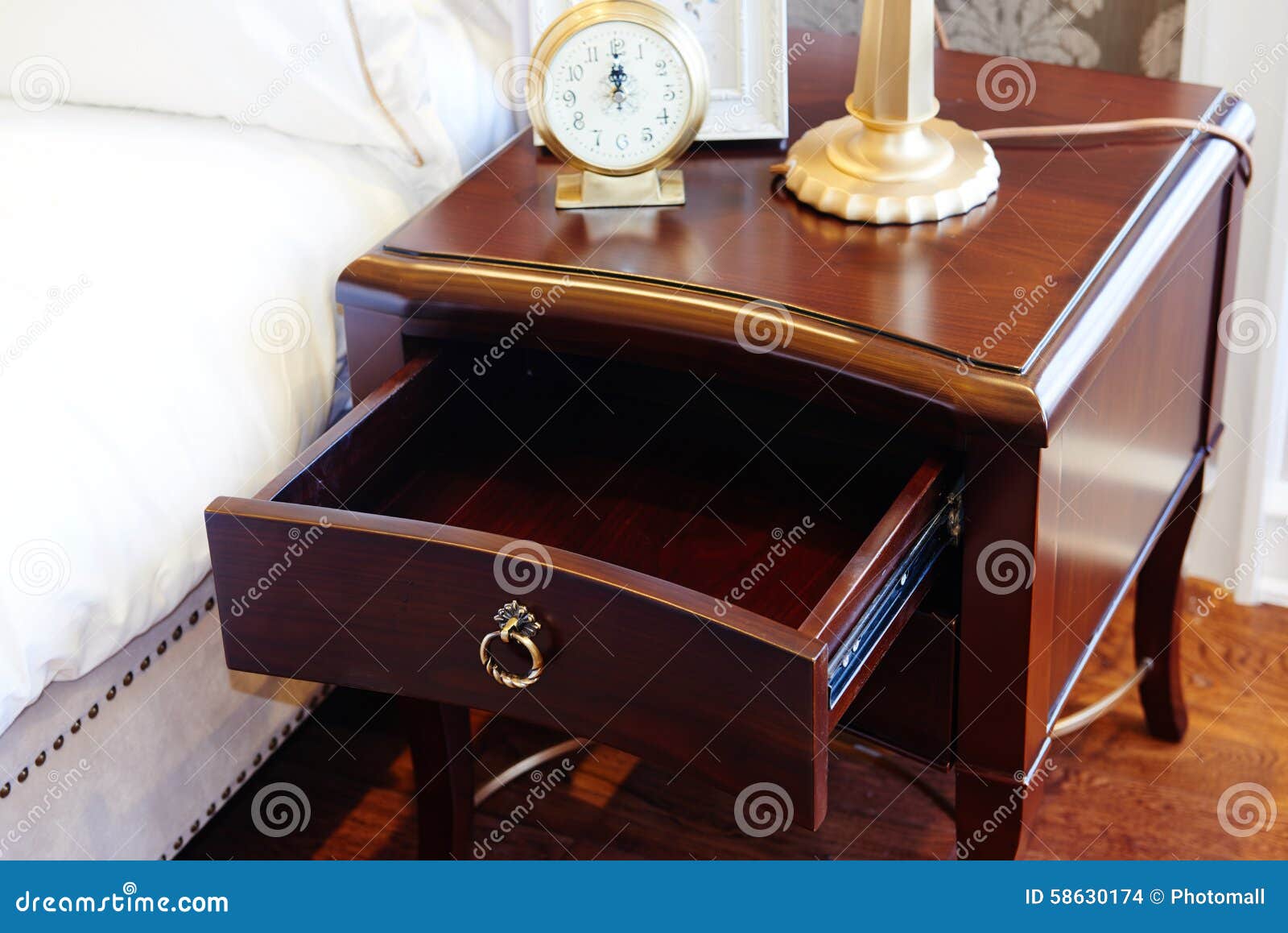 Bedside table in bedroom stock photo. Image of cushion - 58630174