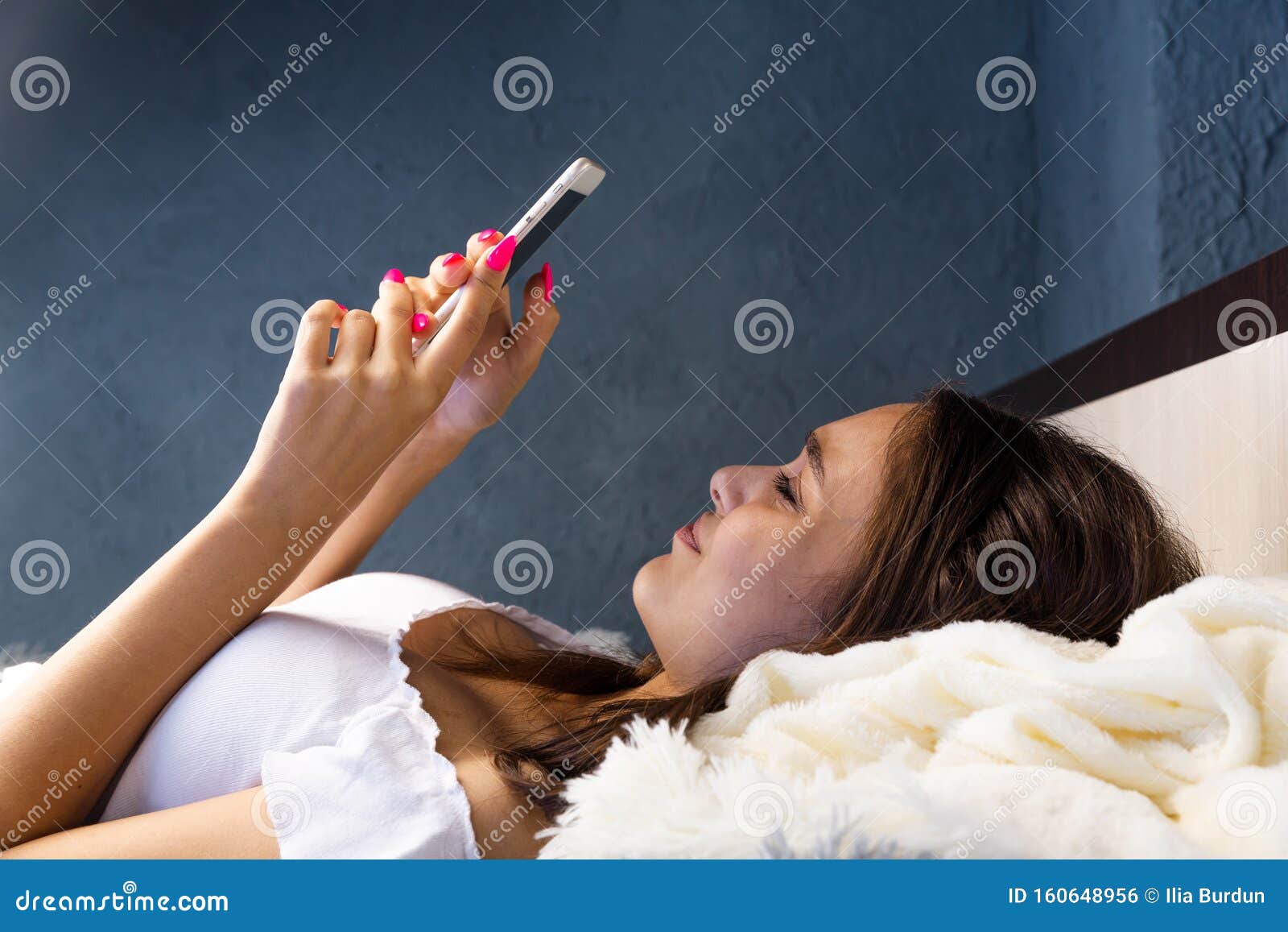 Bedtime Concept. Woman Using Phone in the Bed. Stock Photo - Image of ...
