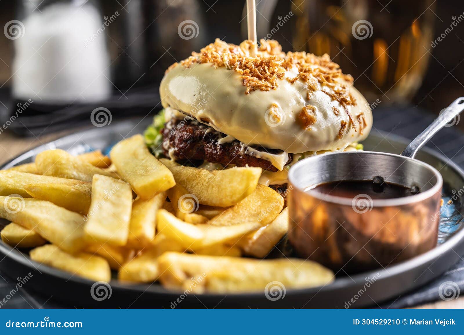 Beef Burger Topped with Cheese with Fries and Draft Beer on a Pub or ...