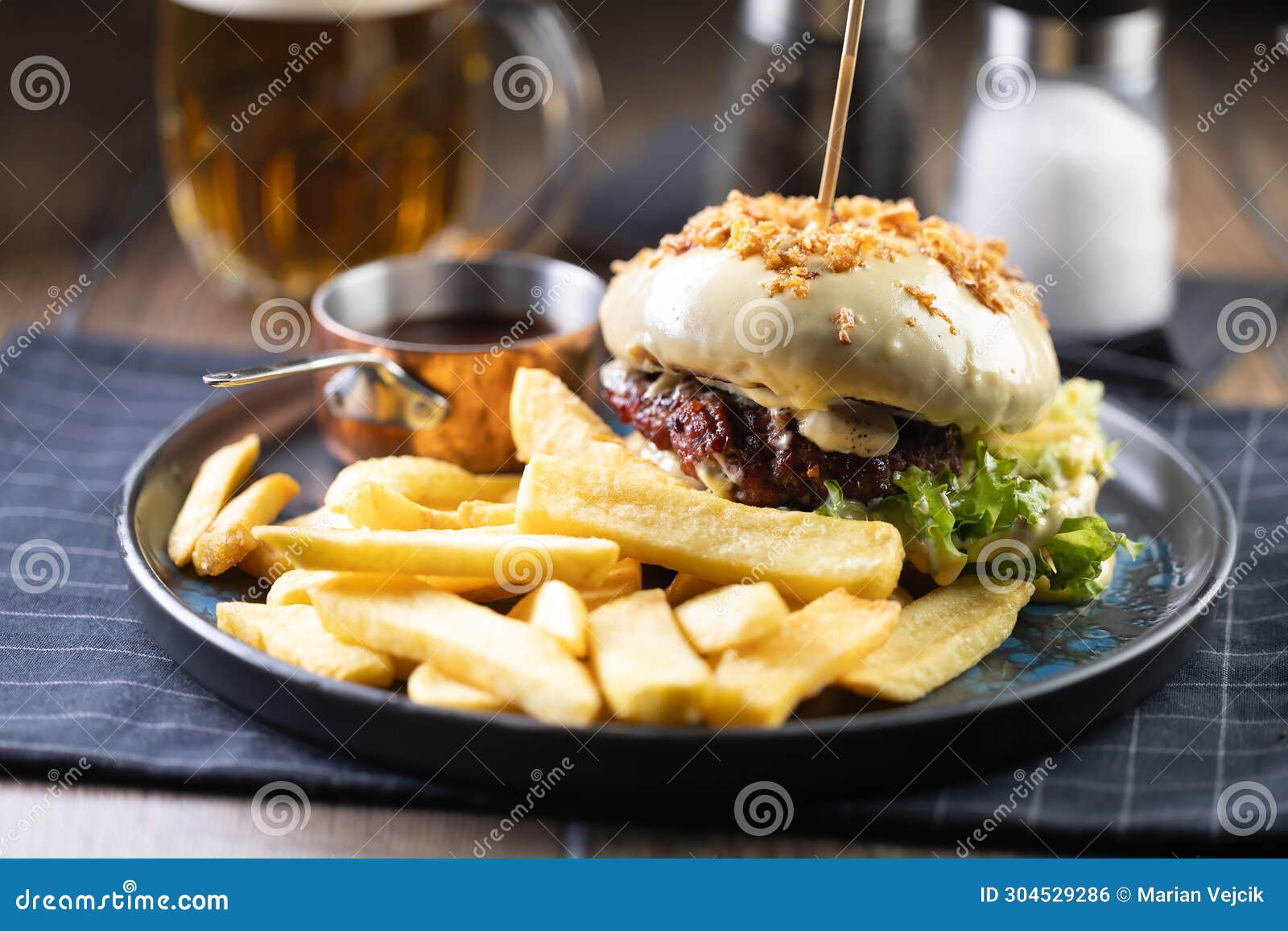 Beef Burger Topped with Cheese with Fries and Draft Beer on a Pub or ...