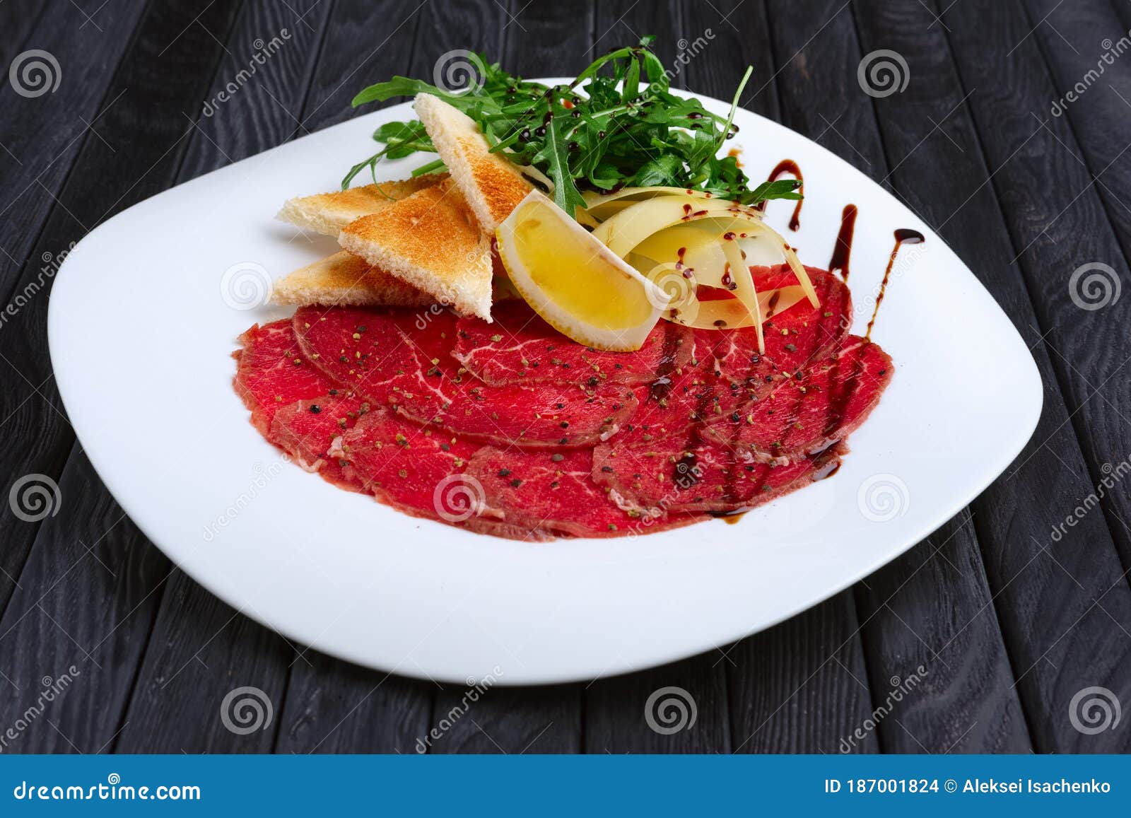 Beef Carpaccio with Cheese, White Bread Toasts and Lemon Stock Photo ...
