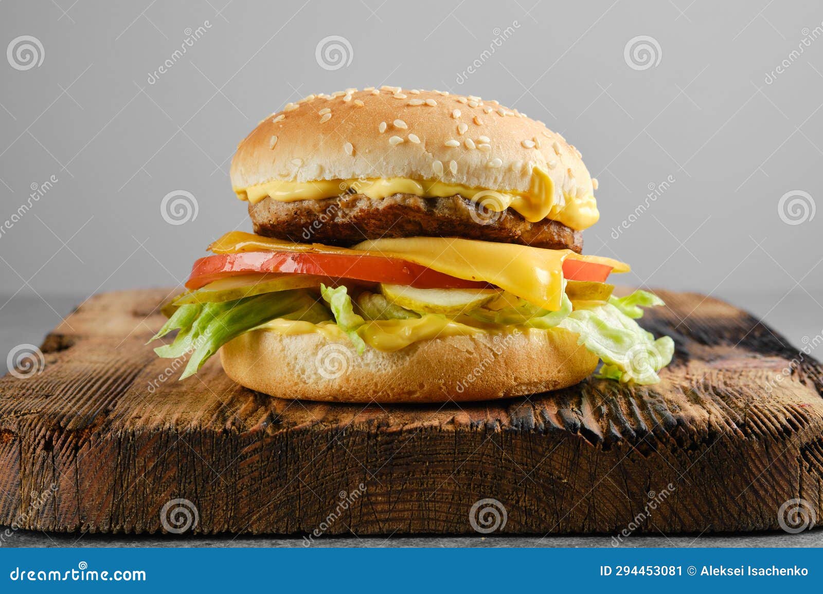 Beef Cheeseburger with Vegetables and Cheesy Sauce, Front View Stock ...